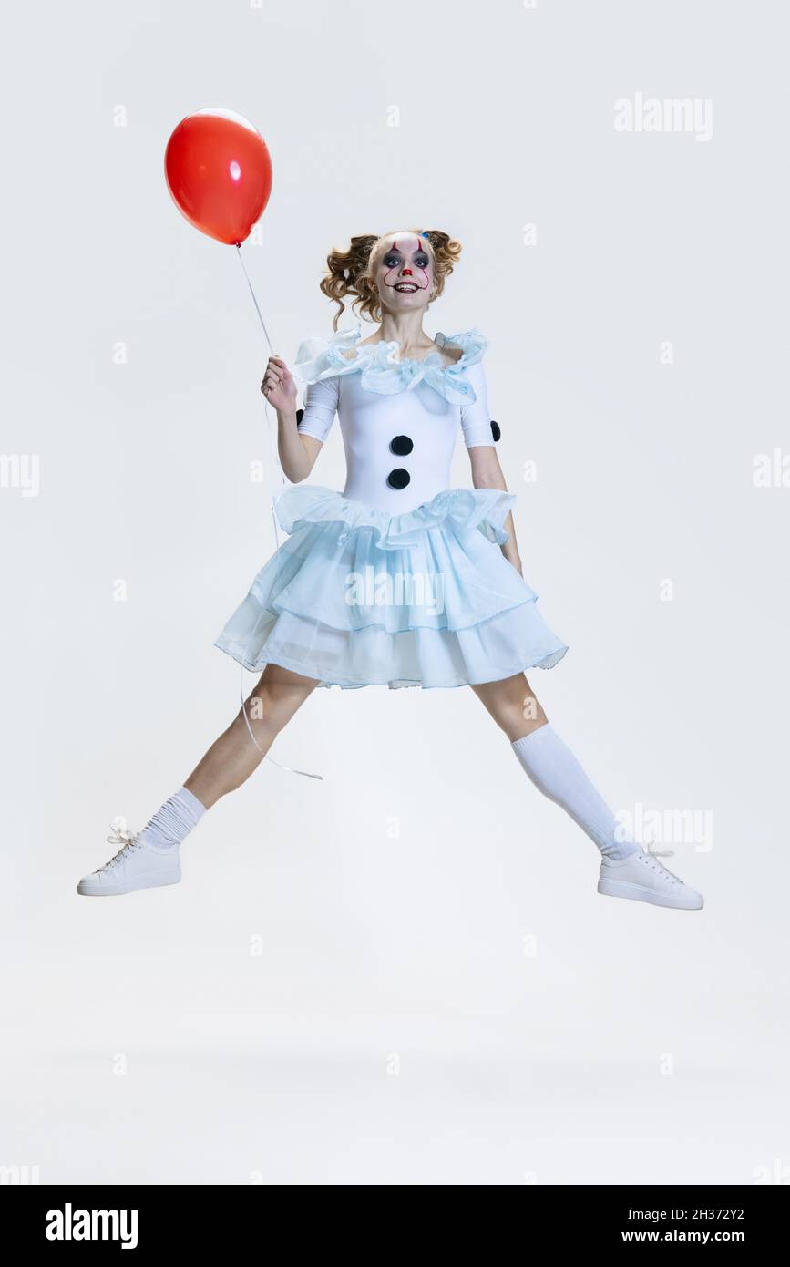 Full-length portrait of young girl wearing Halloween dress, costume of ...