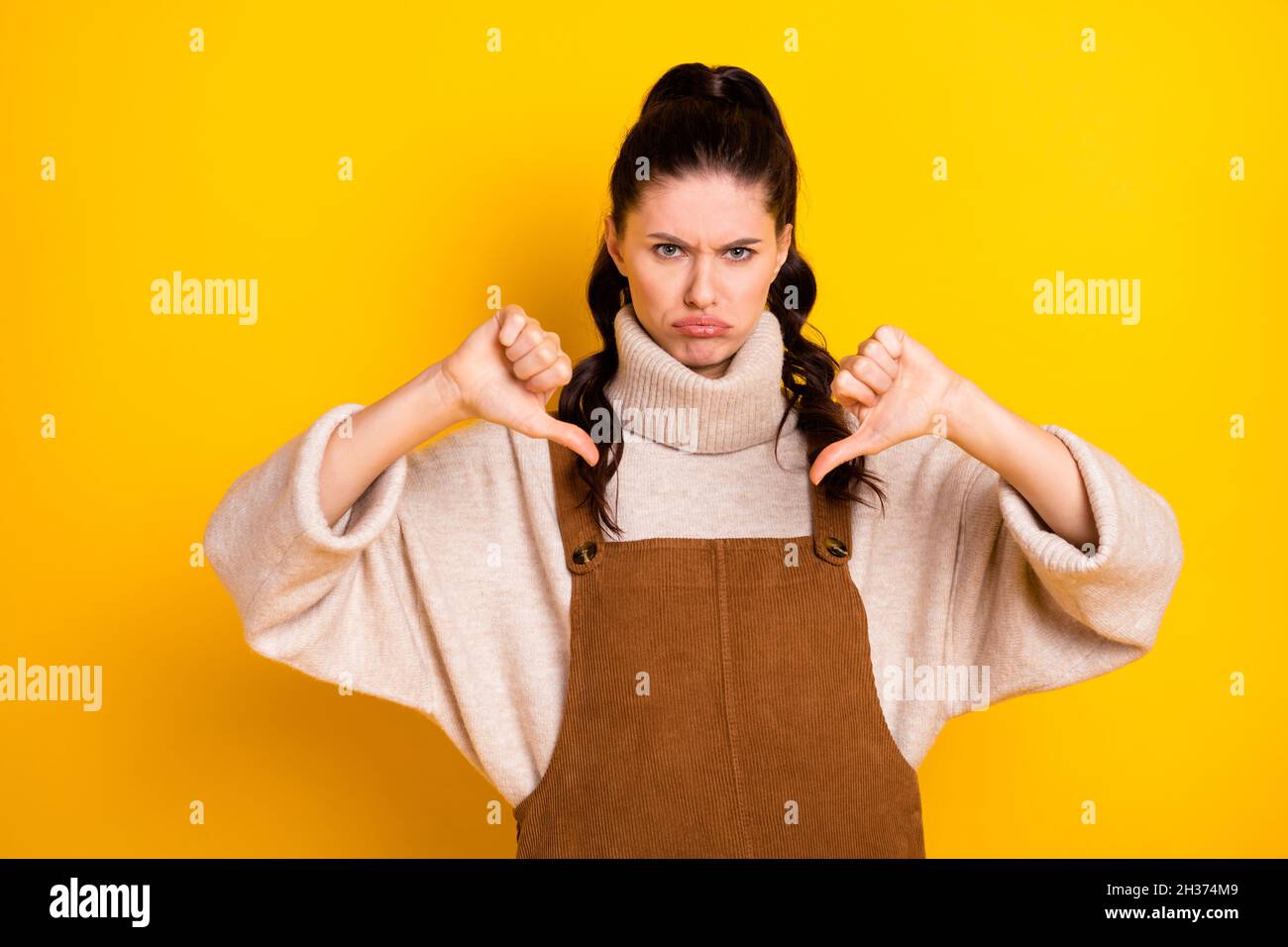 Portrait of attractive trendy grumpy dissatisfied girl showing thumb ...