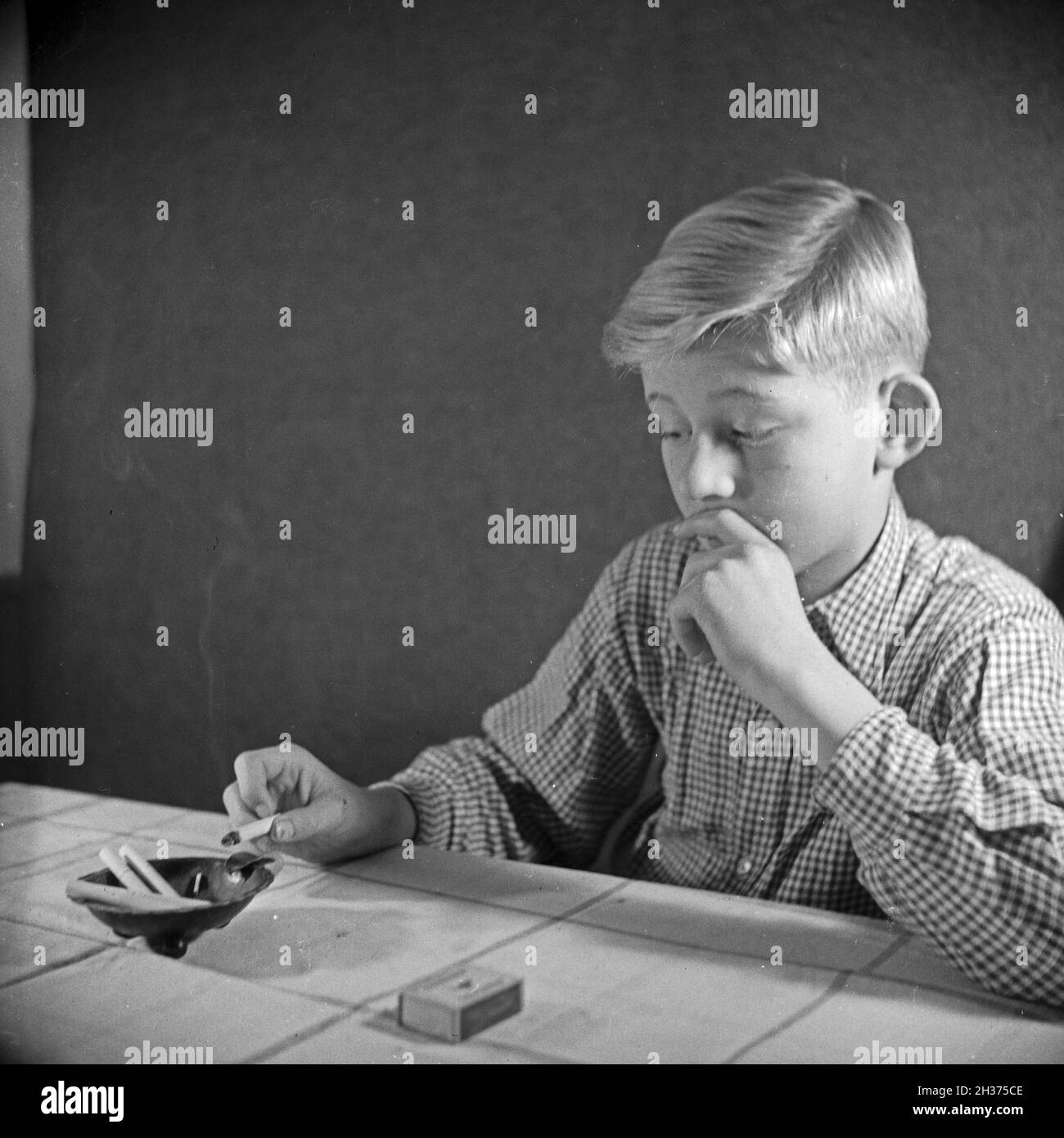 Smoking cigarette child Black and White Stock Photos & Images - Alamy