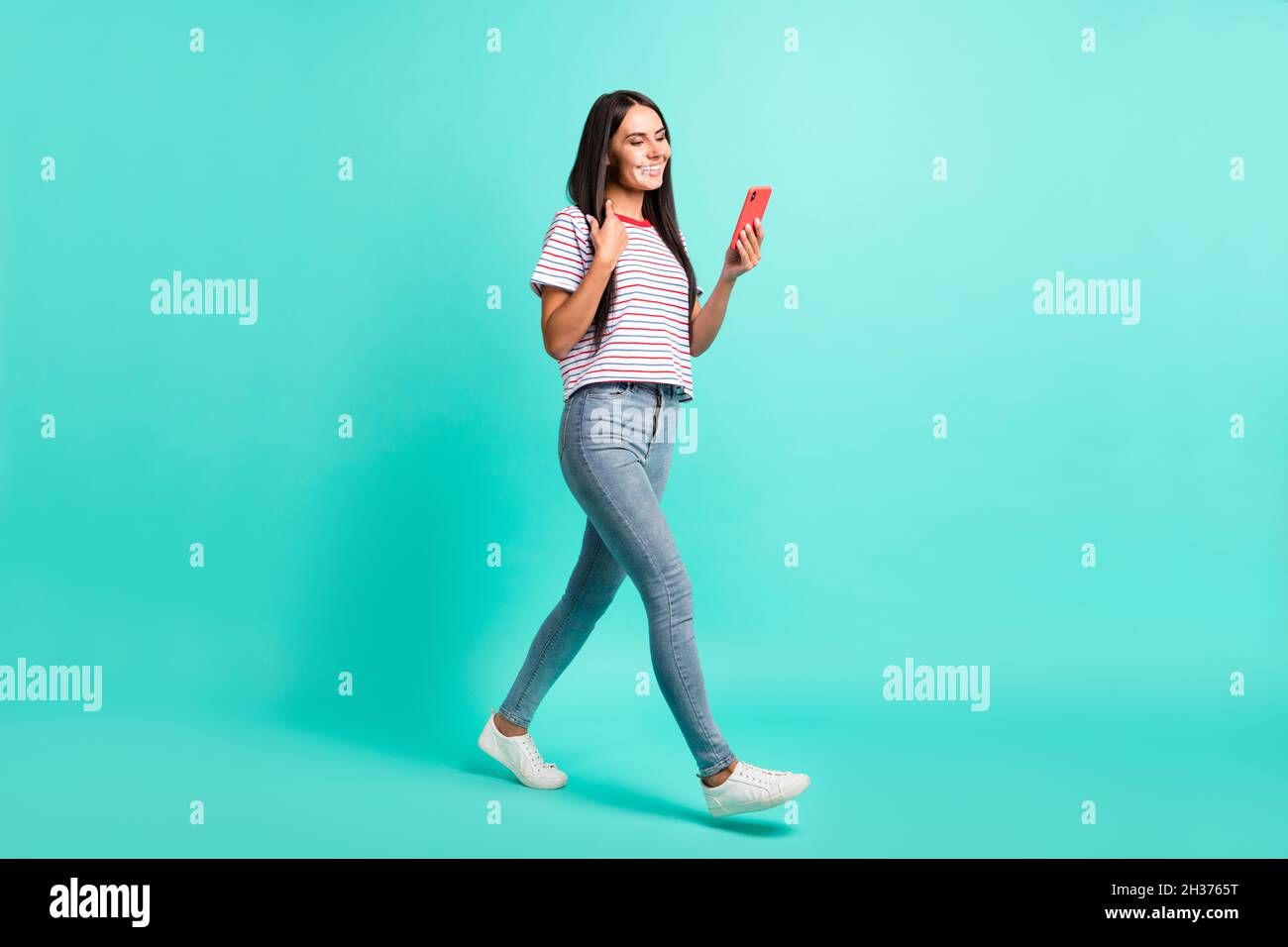 Full size profile portrait of pretty positive person walking tying post ...