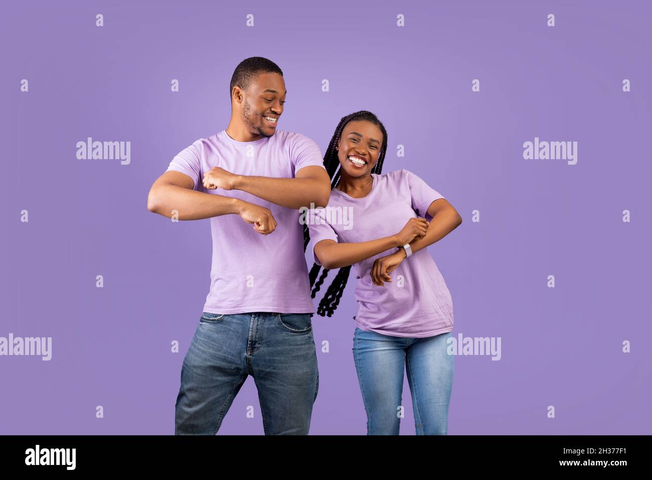 Portrait of cheerful positive black couple dancing at studio Stock ...