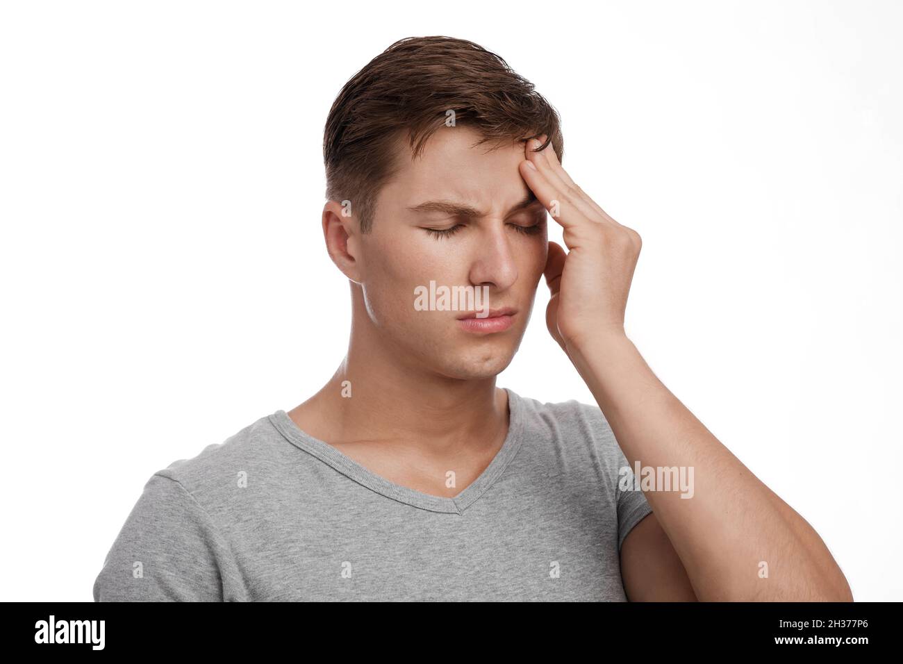 Despaired sad attractive young caucasian guy suffering from headache ...