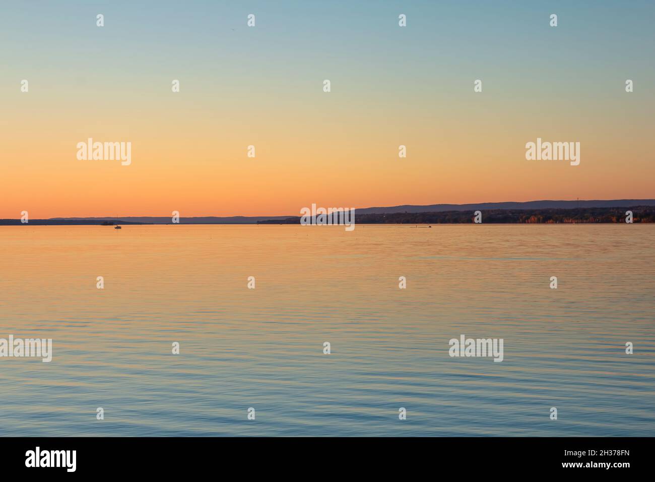 Beautiful sunset reflecting on gently rippled water Stock Photo - Alamy
