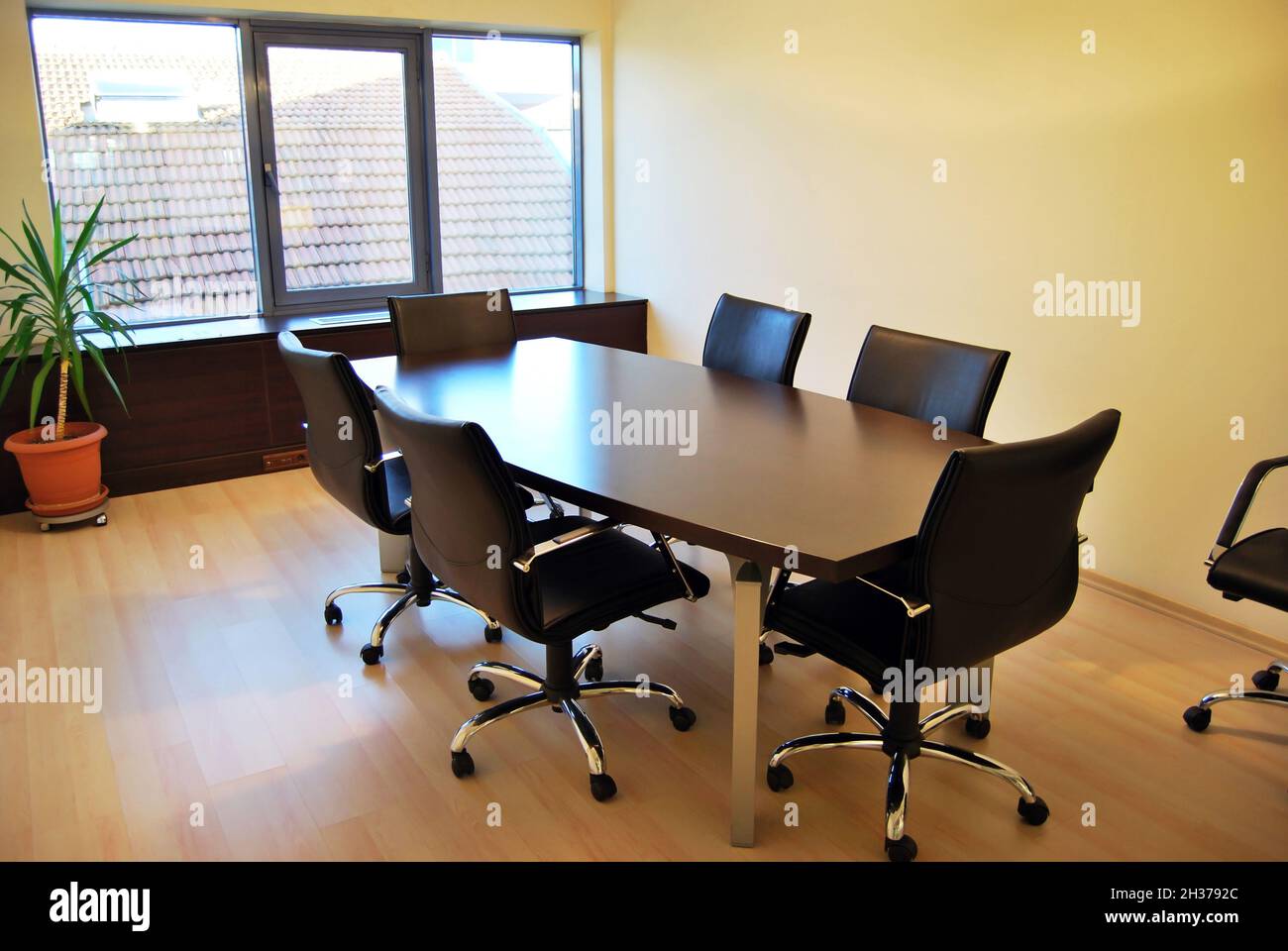 Empty meeting table and chairs in a modern conference room. Business ...