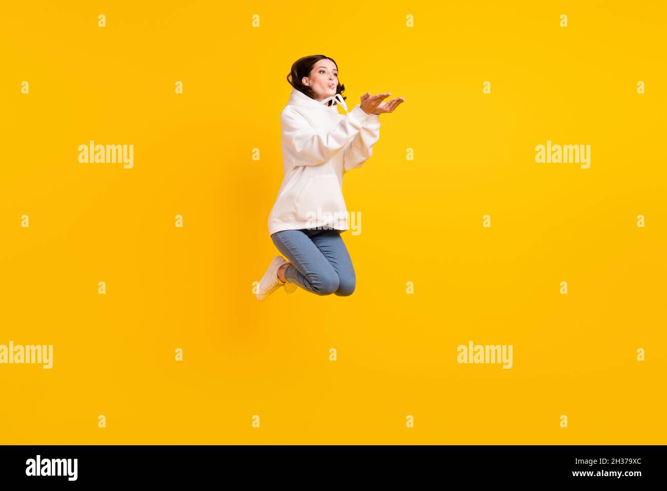 Full Length Body Size View Of Attractive Affectionate Girl Jumping