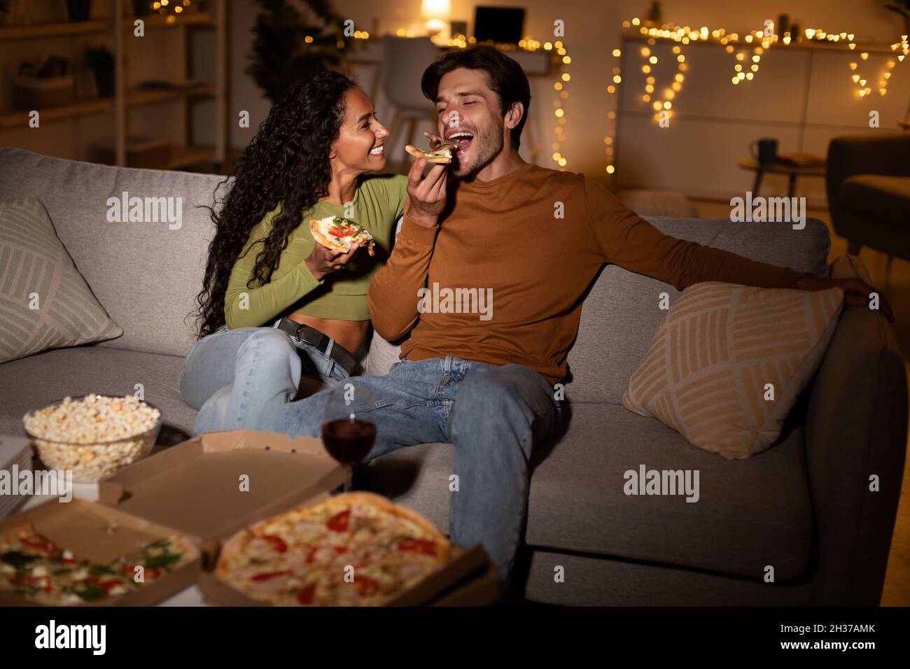 Cheerful Husband And Wife Eating Pizza Watching Movie At Home Stock ...