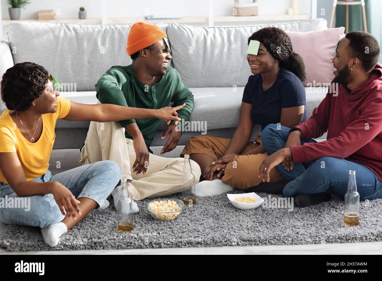 Cheerful african american millennials playing games while chilling ...