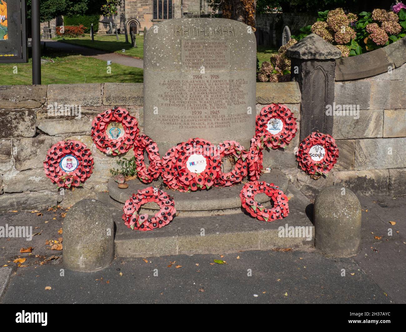 poppy wreaths laid on the war memorial to the fallen of WW1 and WW2 ...