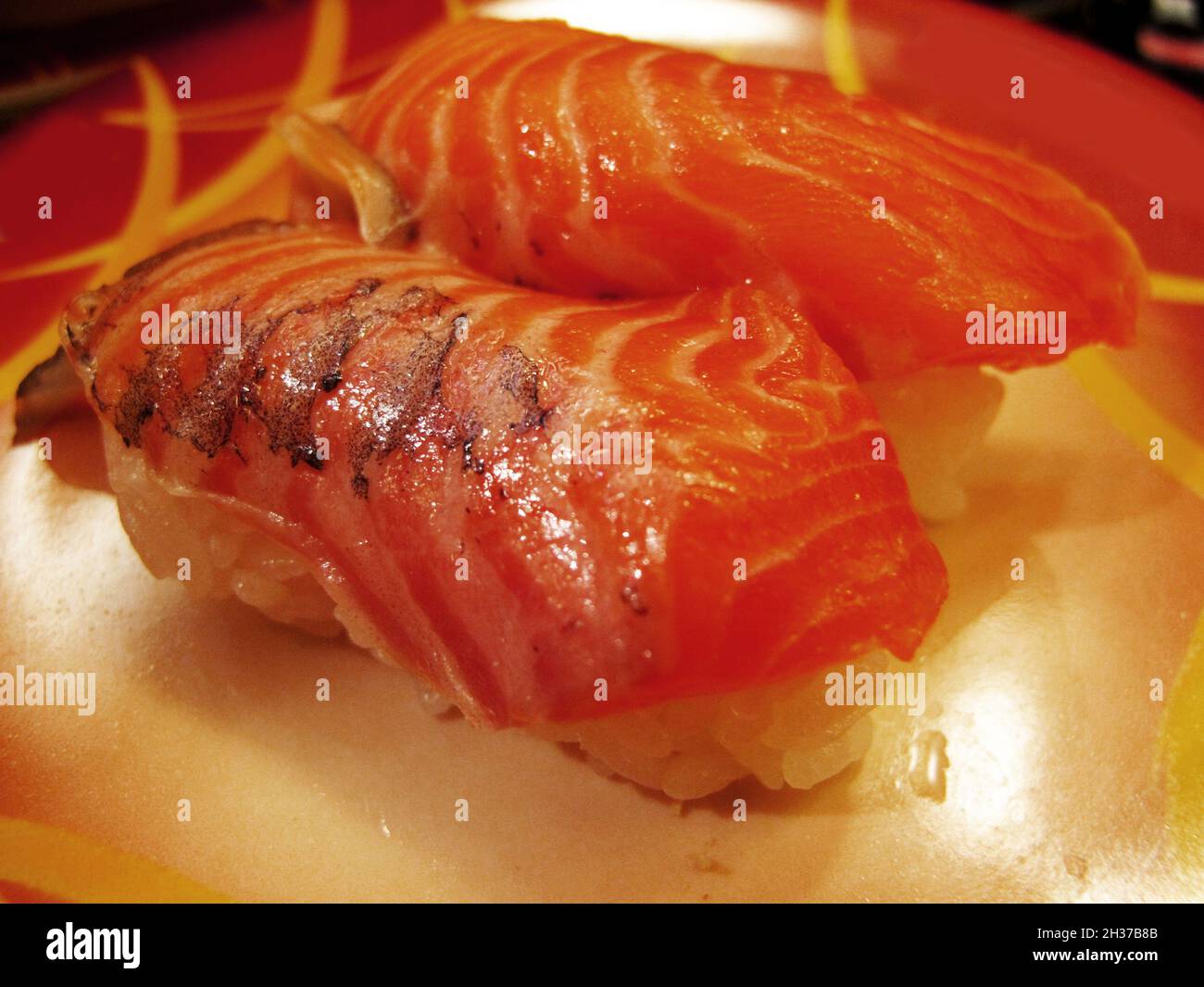 Sushi Traditional Japanese dish of prepared vinegared rice on topping ...
