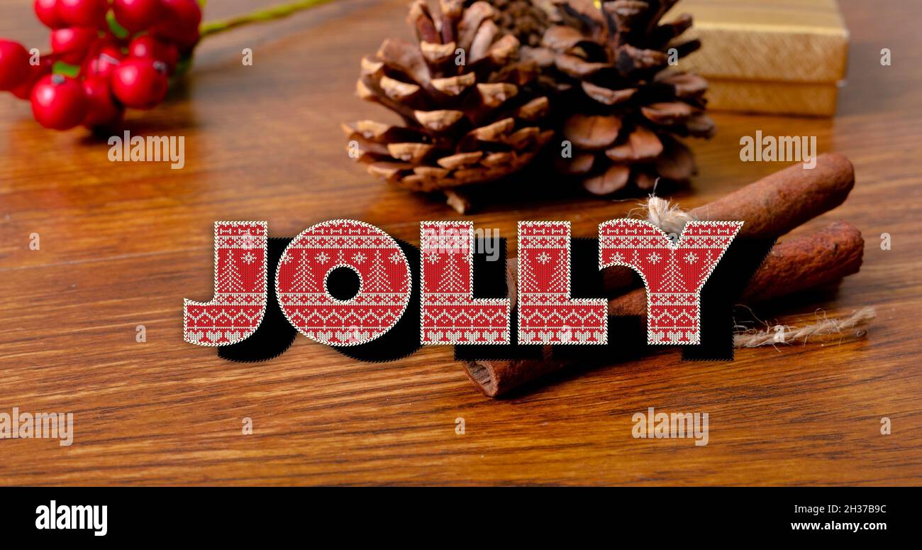 Composition of jolly text over christmas decorations on table Stock ...