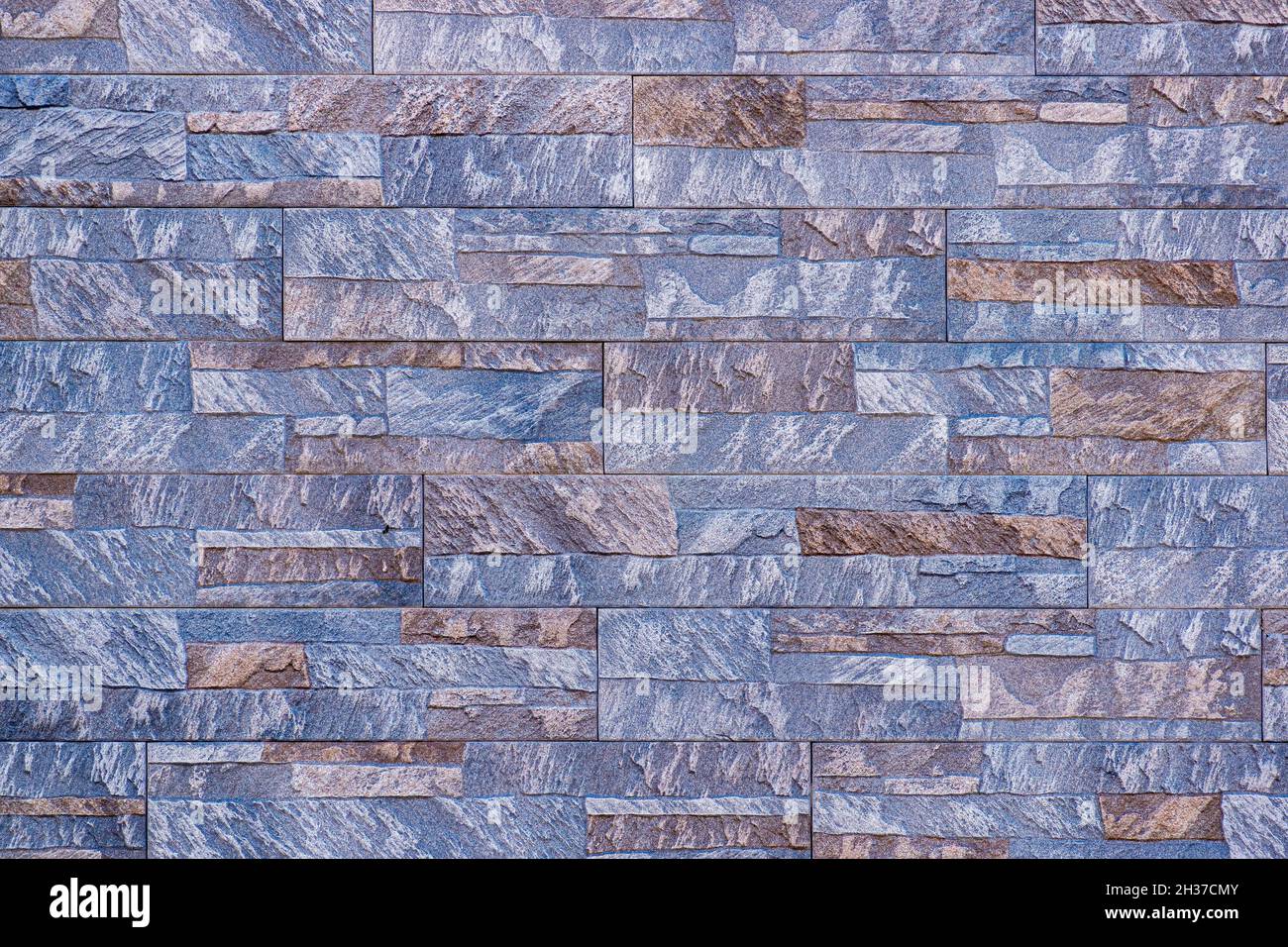 Blue stone wall with a textured surface Stock Photo - Alamy