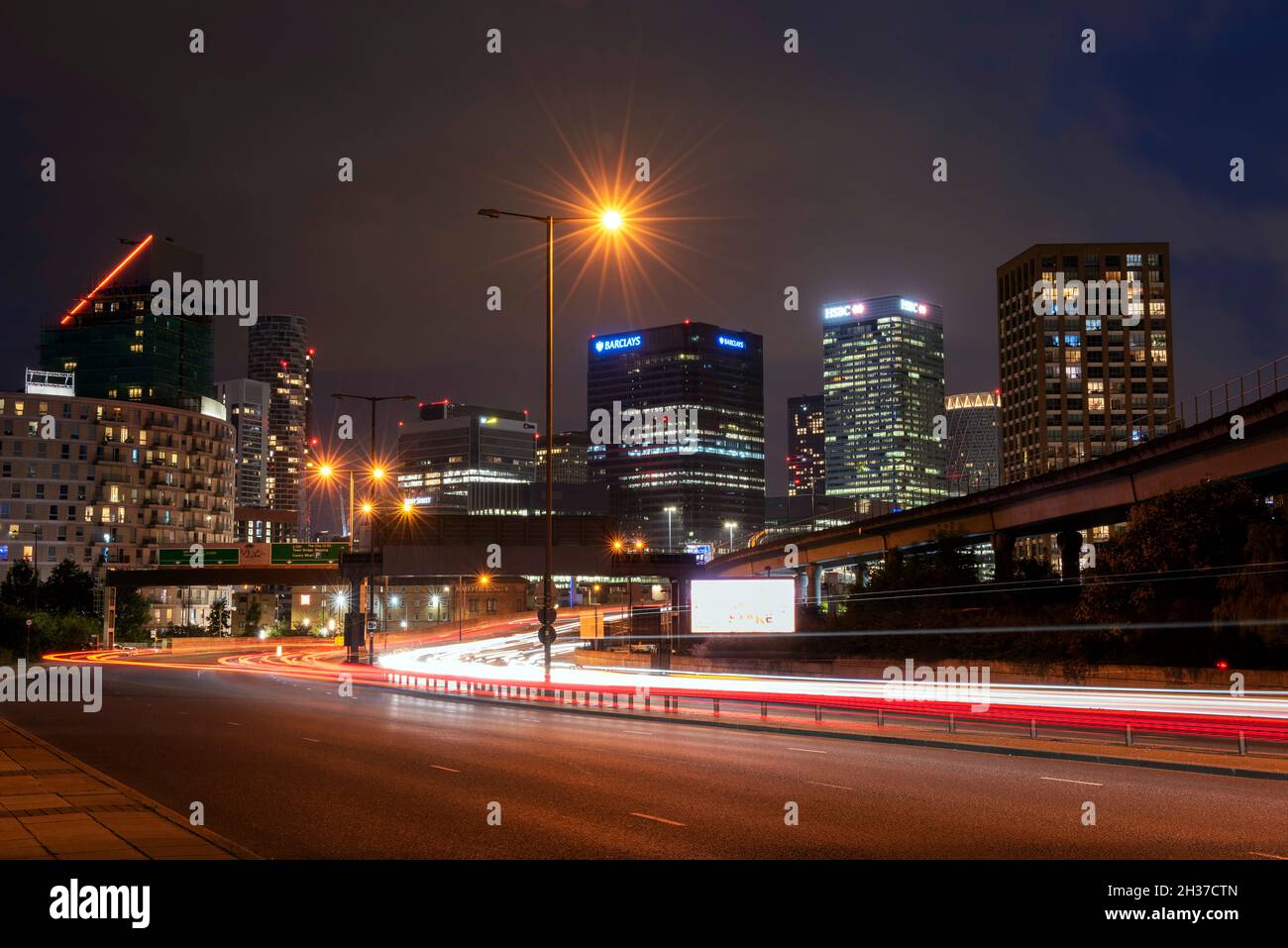 Traffic light trails on Aspen Way looking towards Canary Wharf, London ...
