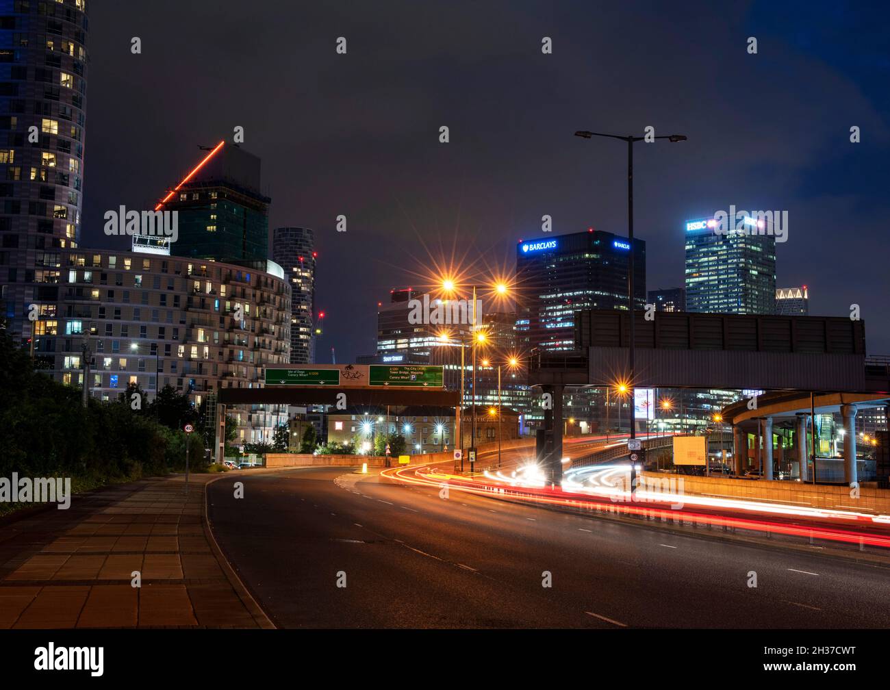 Traffic light trails on Aspen Way looking towards Canary Wharf, London ...