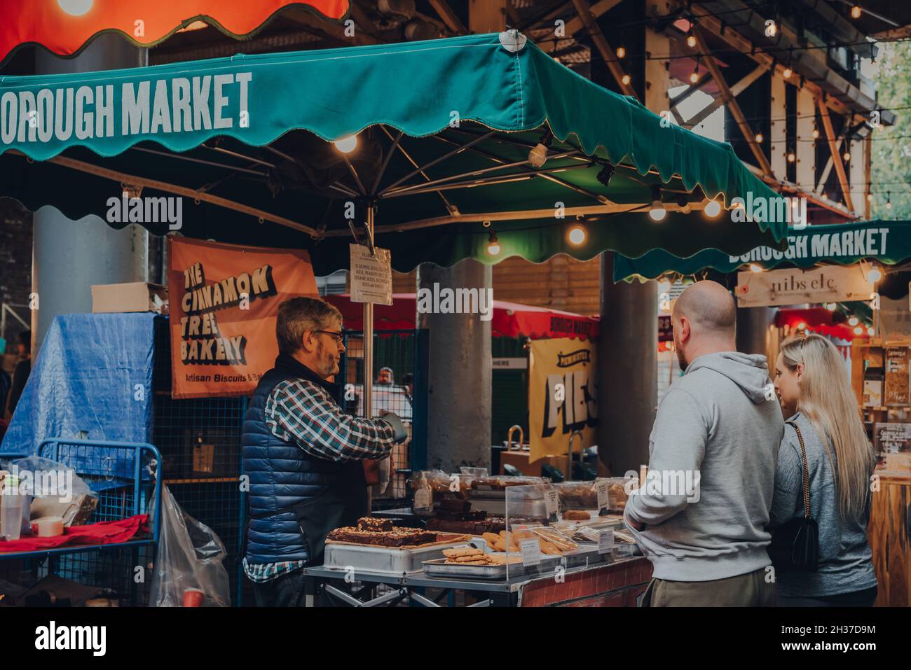 London, UK - October 17, 2021: Seller and customer at a The Cinnamon ...