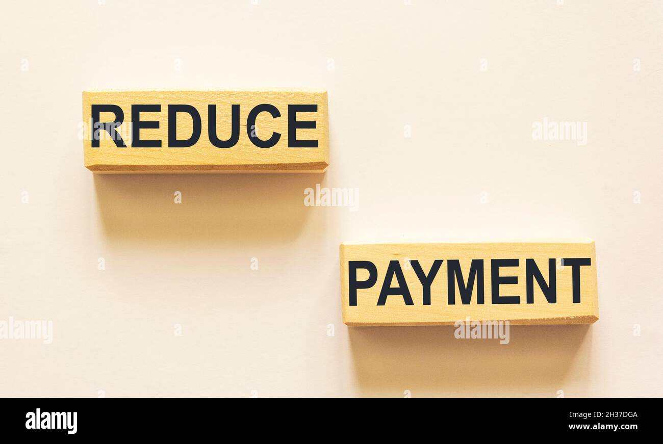 Wooden blocks with the words Reduce payment. Business concept Stock ...