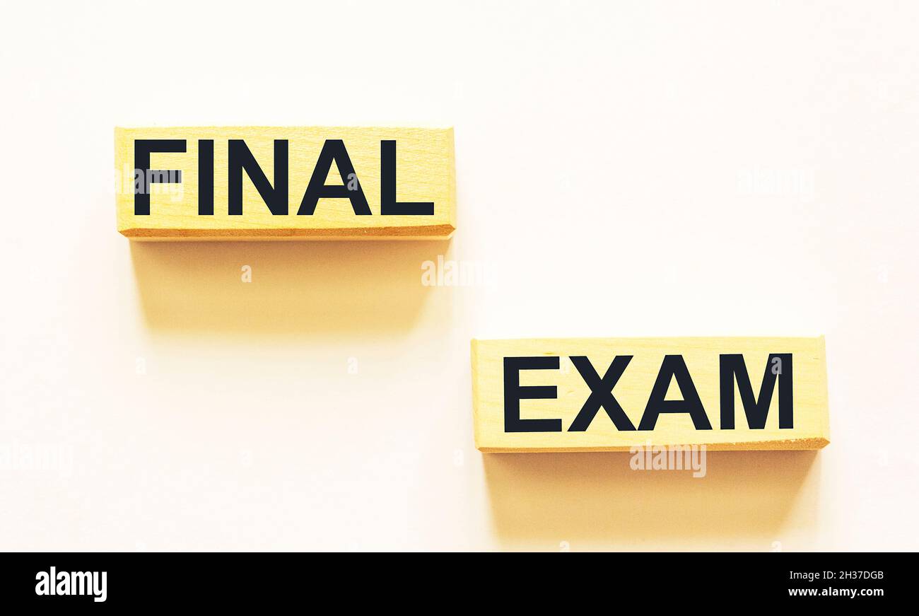 The text of the Final Exam is written on wooden blocks on a white ...