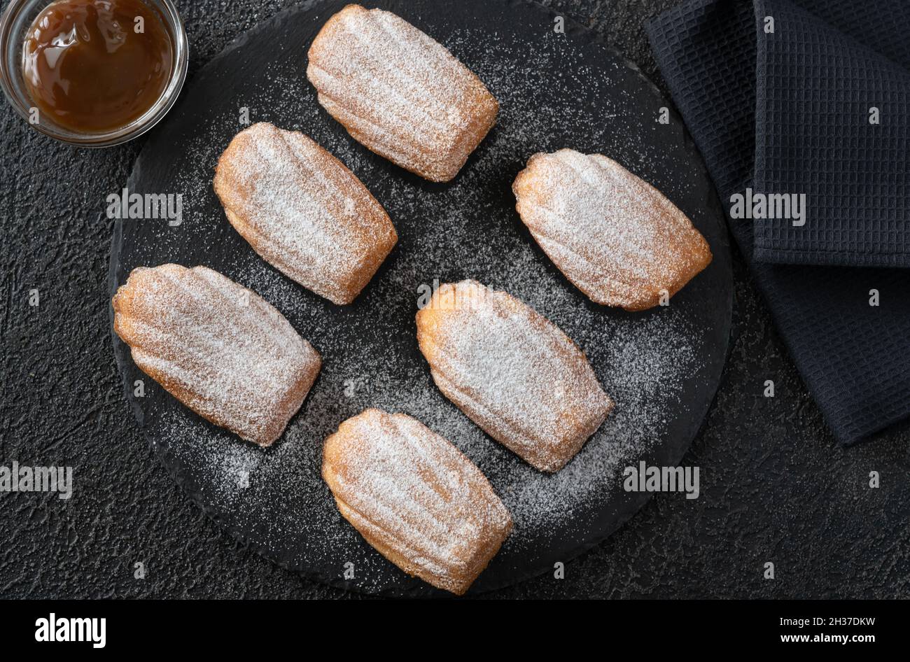 Madeleines - French small sponge cakes on the stone board Stock Photo ...