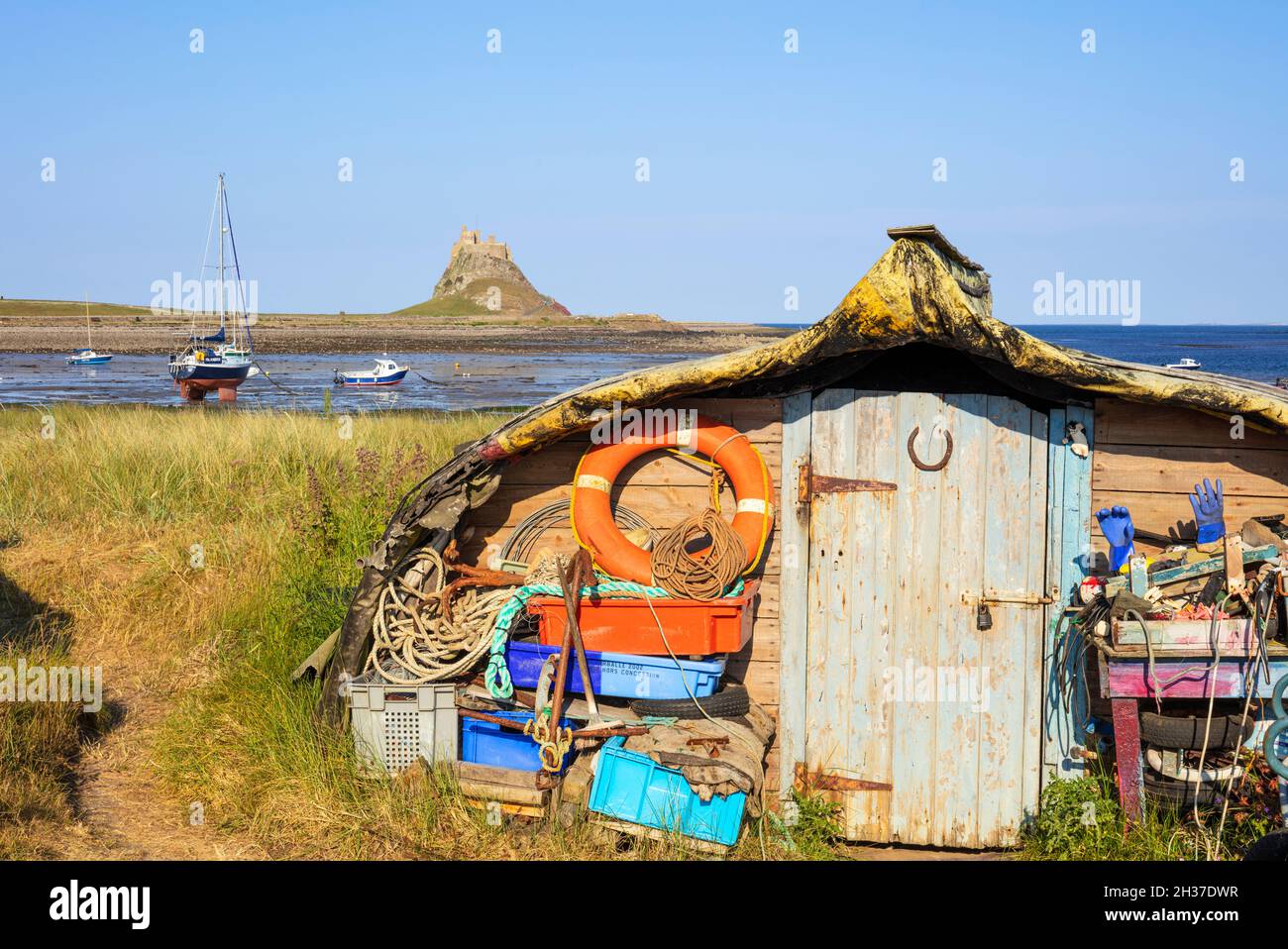 Lindisfarne Upturned boat storage use in front of Lindisfarne Castle ...