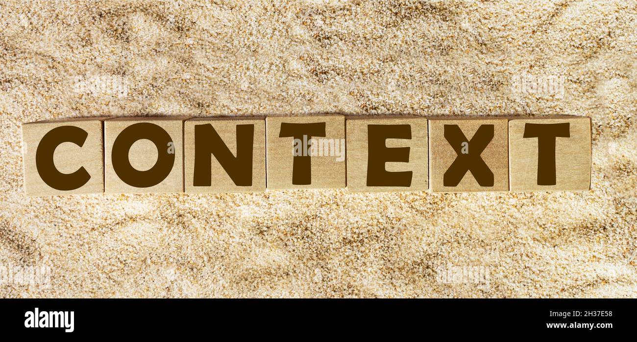 CONTEXT Word written on wooden cubes and sand background Stock Photo ...