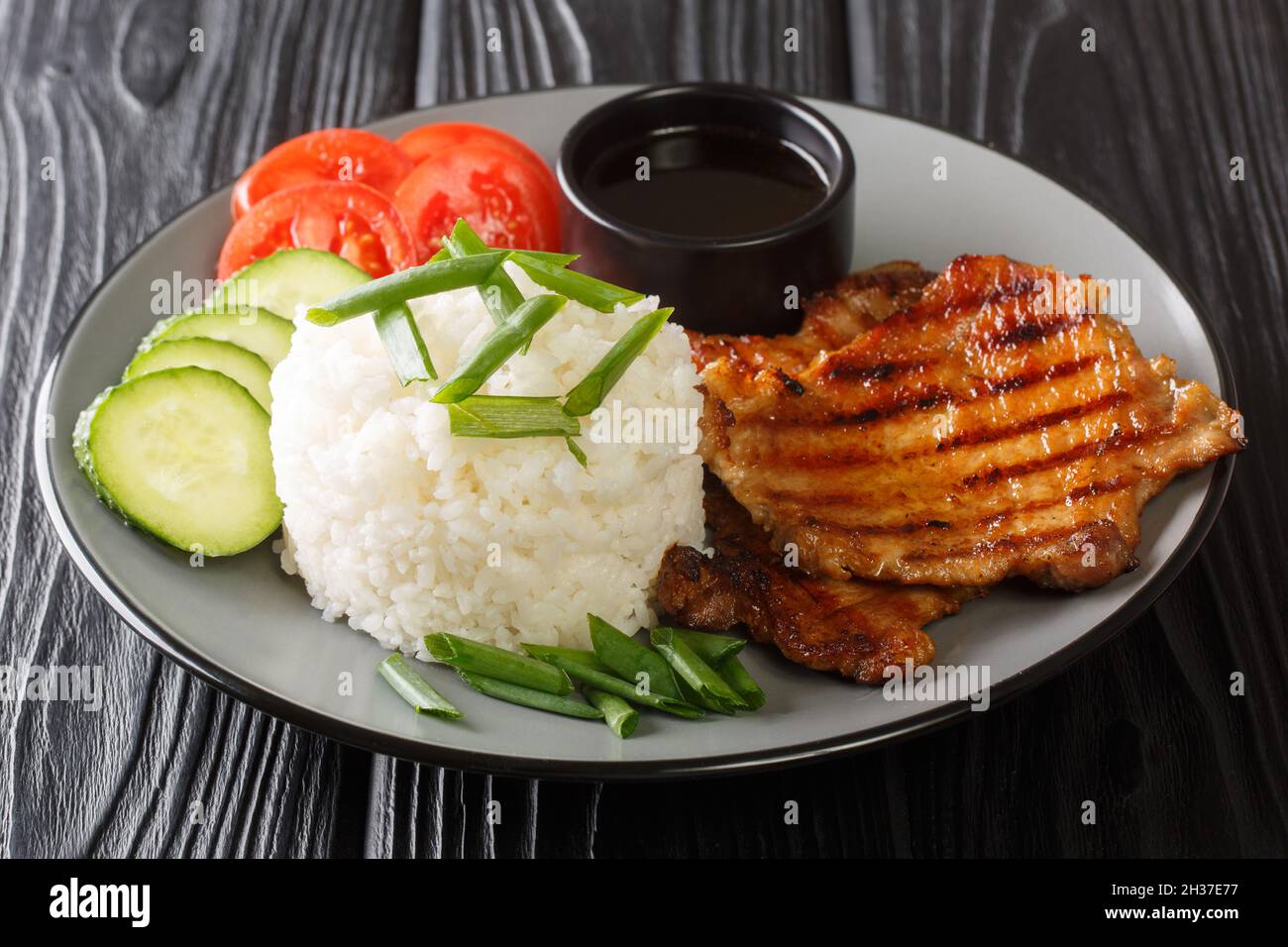 Com Tam Vietnamese Broken Rice with Grilled Pork close-up in a plate on ...