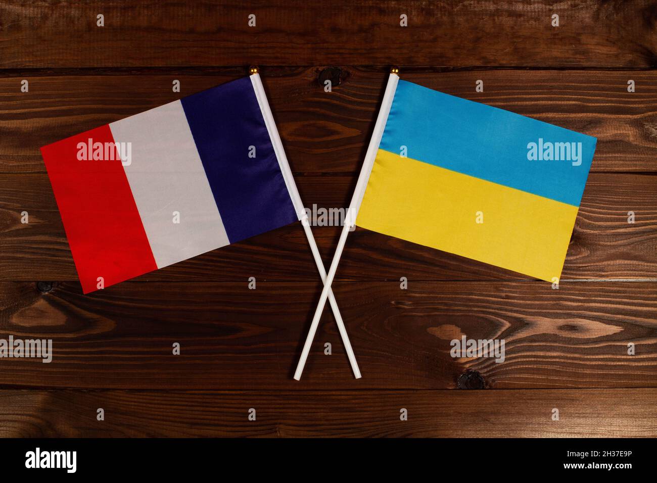 Flag of France and flag of Ukraine crossed with each other. France vs ...