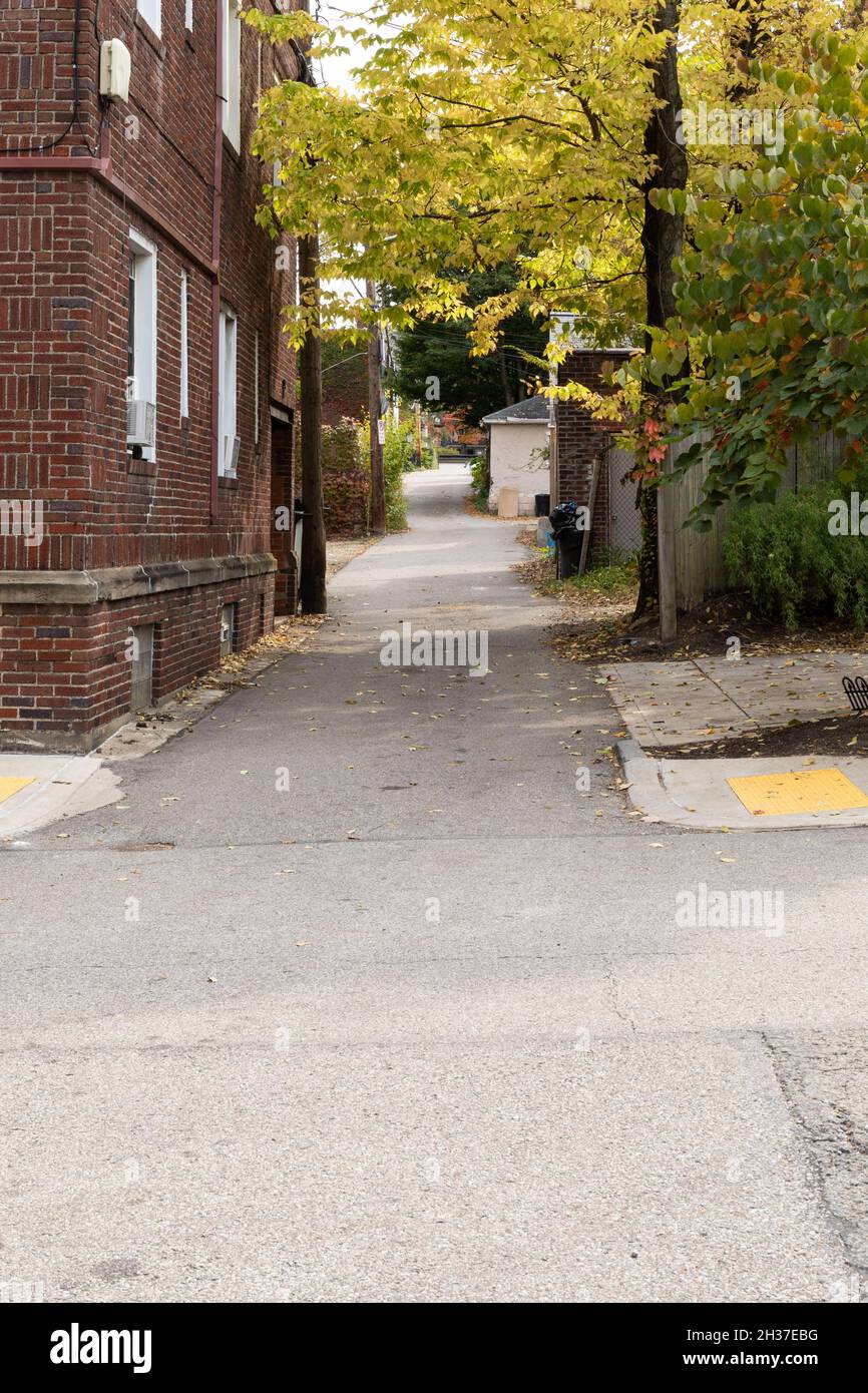 Long alleyway alongside a red brick apartment building, creative copy ...
