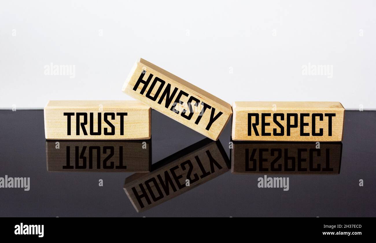 Wooden blocks with the words TRUST, HONESTY, RESPECT, on a white and ...