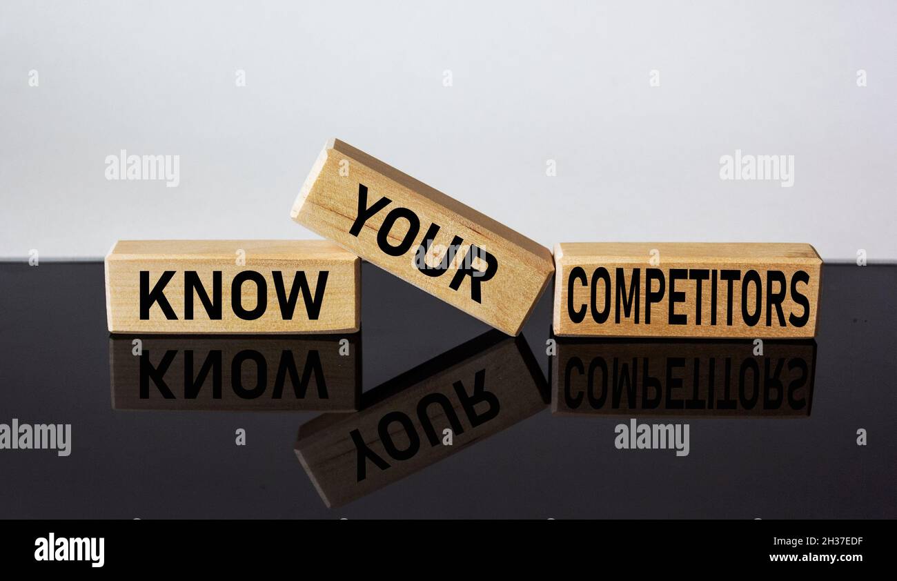 Wooden blocks with the text KNOW YOUR COMPETITORS on a white and black ...