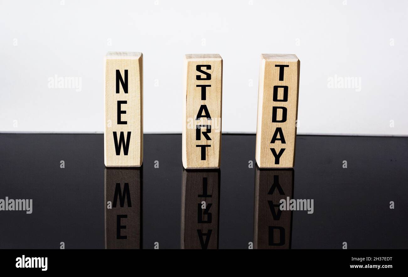 New start today. Concept on wooden blocks and white and black ...