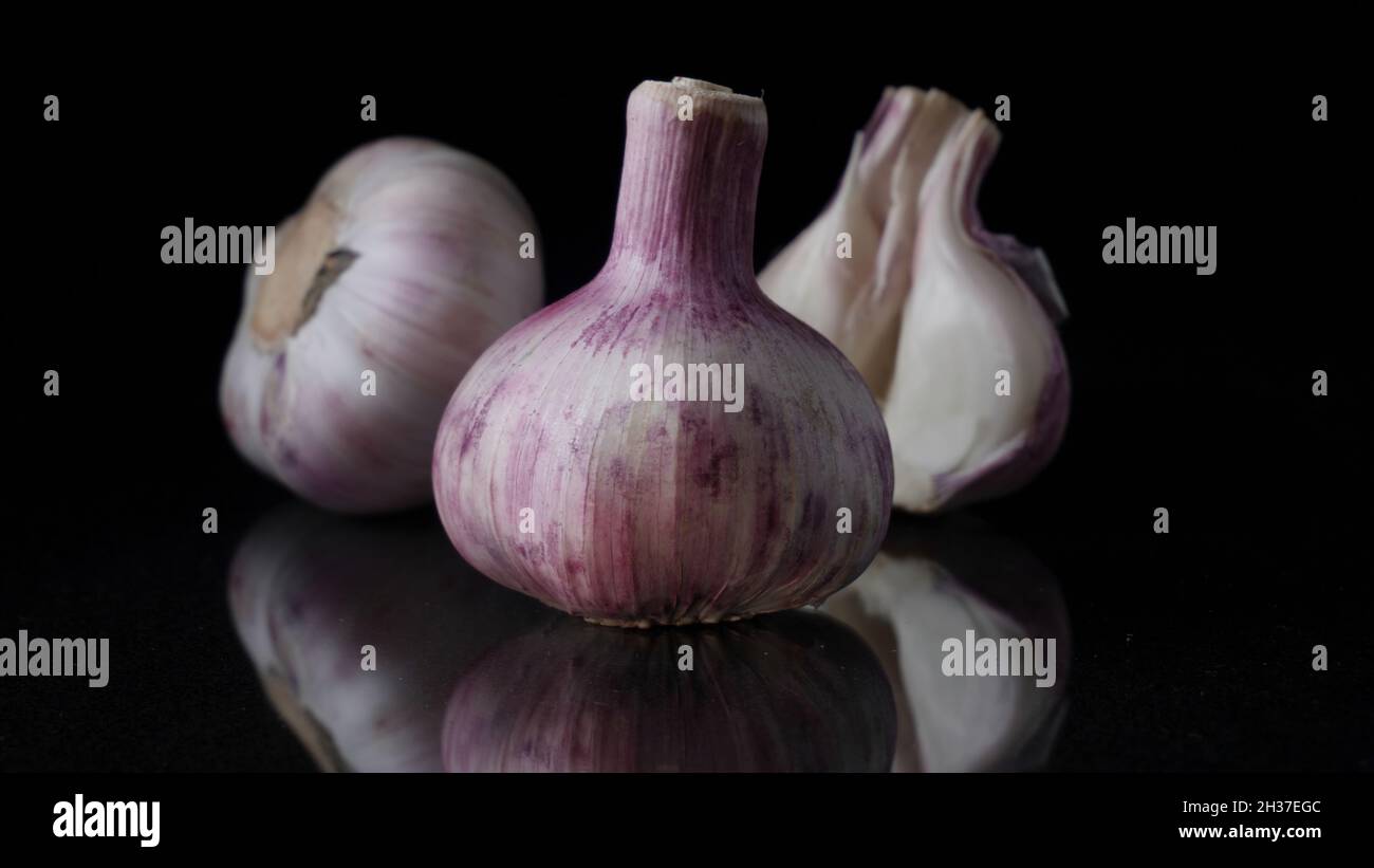 Delicious beautiful garlic on black background. Frame. Concept of a ...