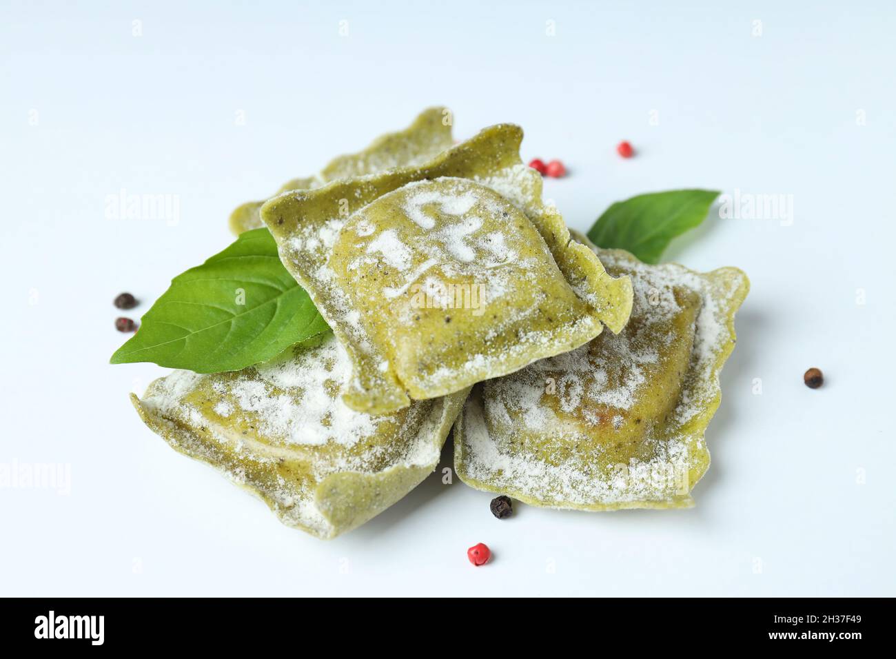 Raw ravioli with spices on white background Stock Photo - Alamy