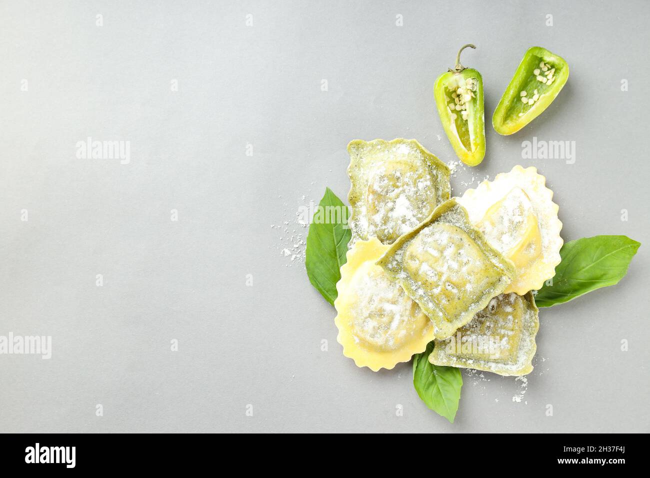 Raw ravioli with spices on light gray background Stock Photo - Alamy