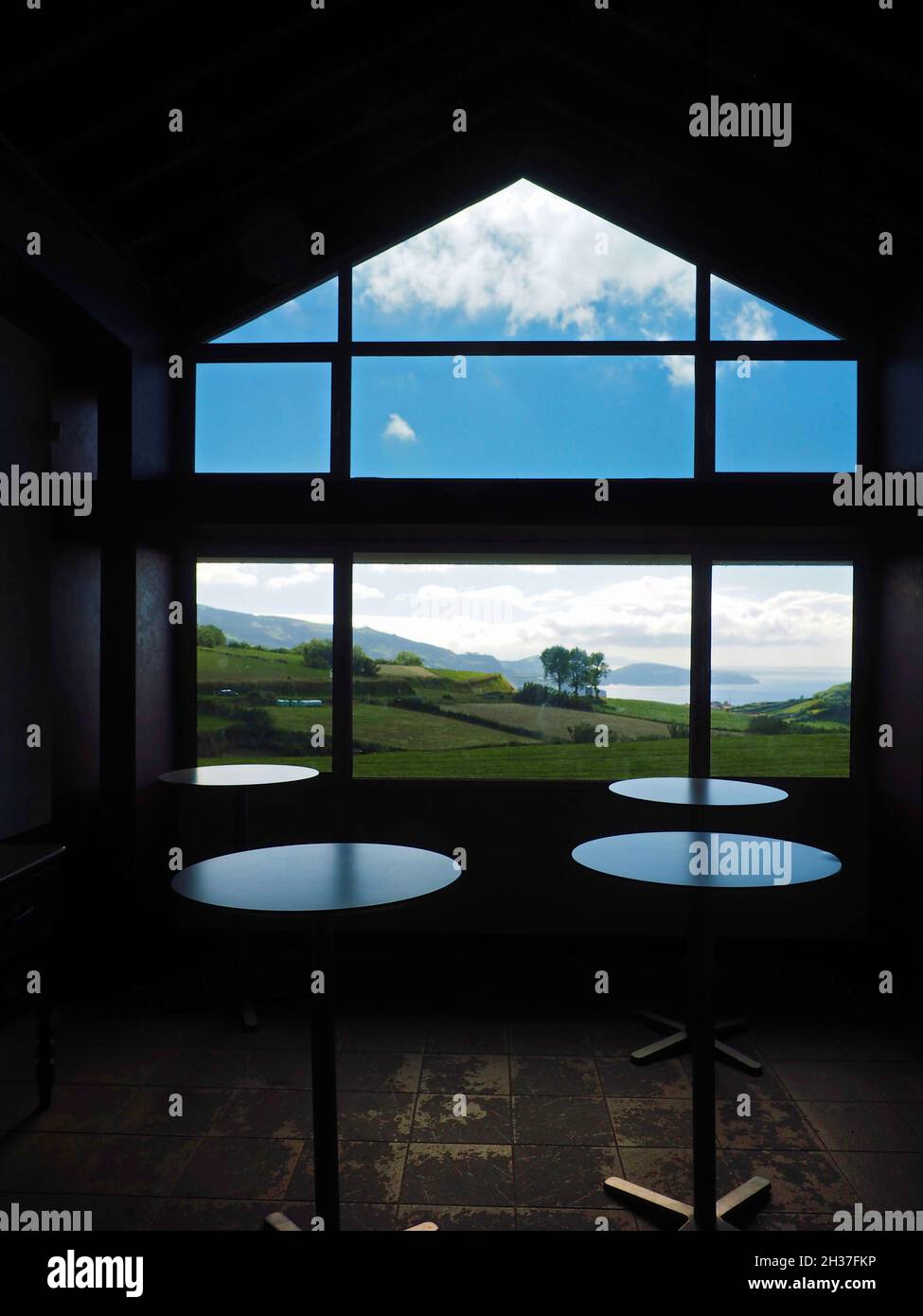 Tables in front of a window on the island of St. Joseph, Portugal Stock ...