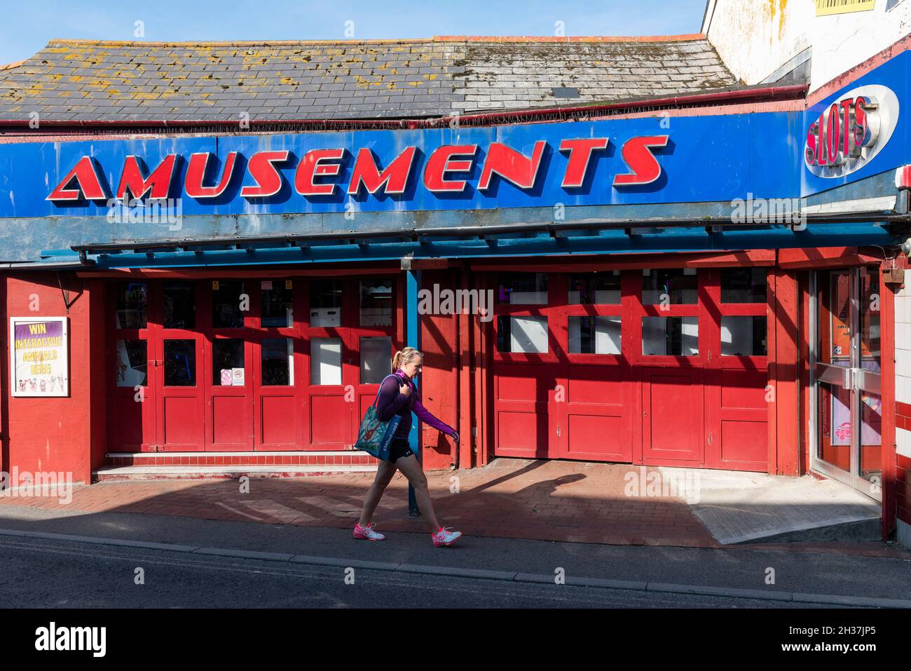 A pedestrian walking past a closed amusement arcade during the off ...