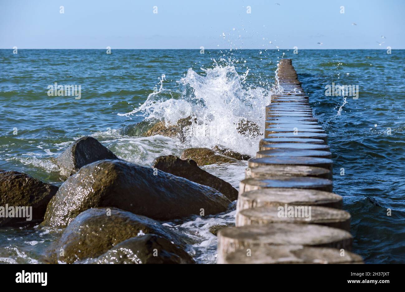 Waves and a storm at sea. Waves crashing on breakwaters. Sea wave ...