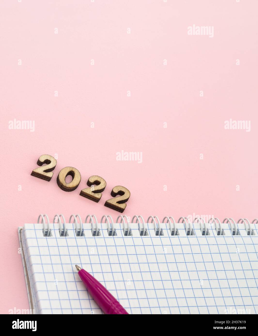 Wooden numbers 2022. Notepad on a spring. Notepad and Pen on Pink. Pink ...