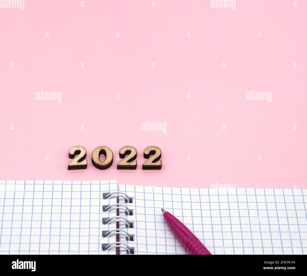 Wooden numbers 2022. Notepad on a spring. Notepad and Pen on Pink. Pink ...