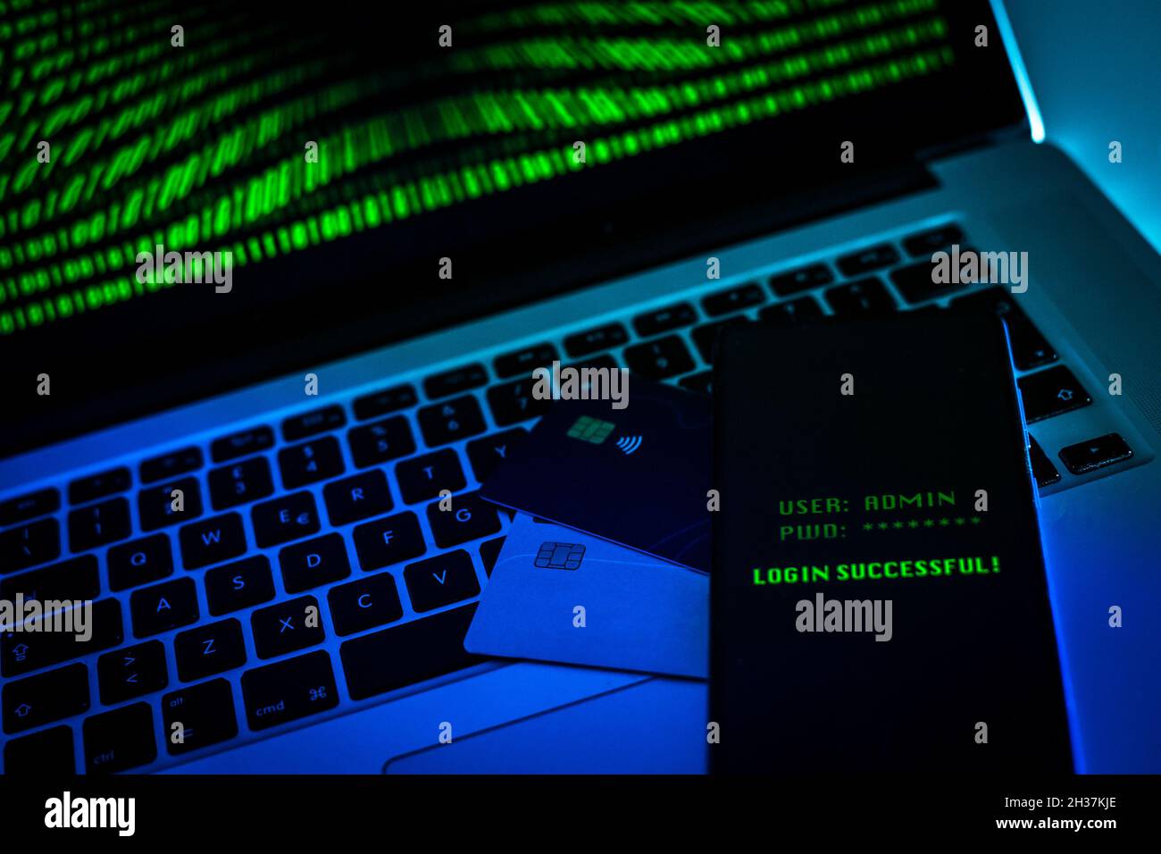 Laptop with green numbers on display. Credit cards, smartphone ...