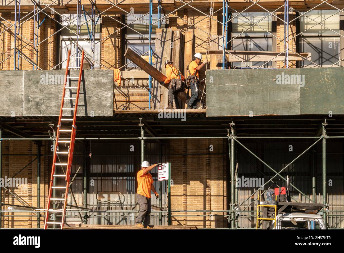 Workers construct a scaffold in Chelsea in New York on Wednesday ...