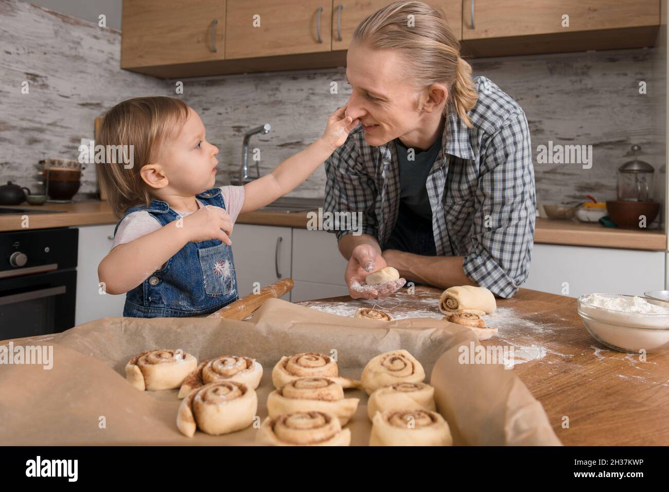 Father and child cooking on the kitchen with fun. Family baking ...