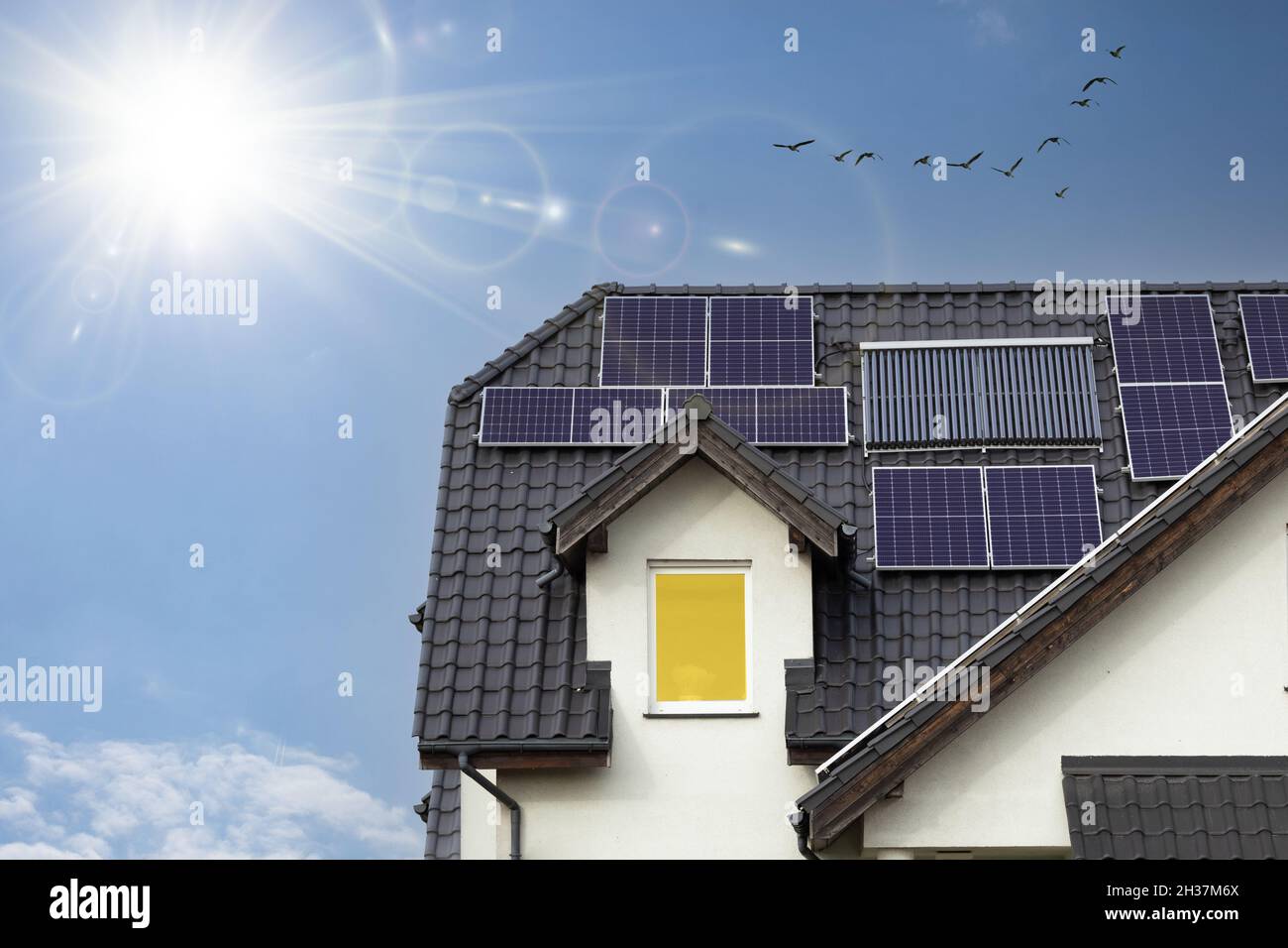 Solar panels on the gable roof of a beautiful modern house. Clear sky ...