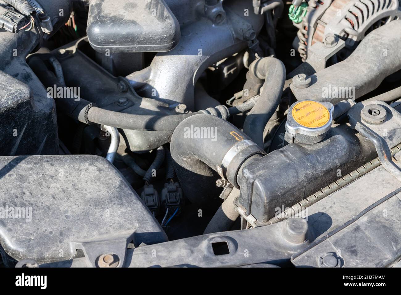 Dusty details of a flat-four (boxer) car engine compartment under the ...