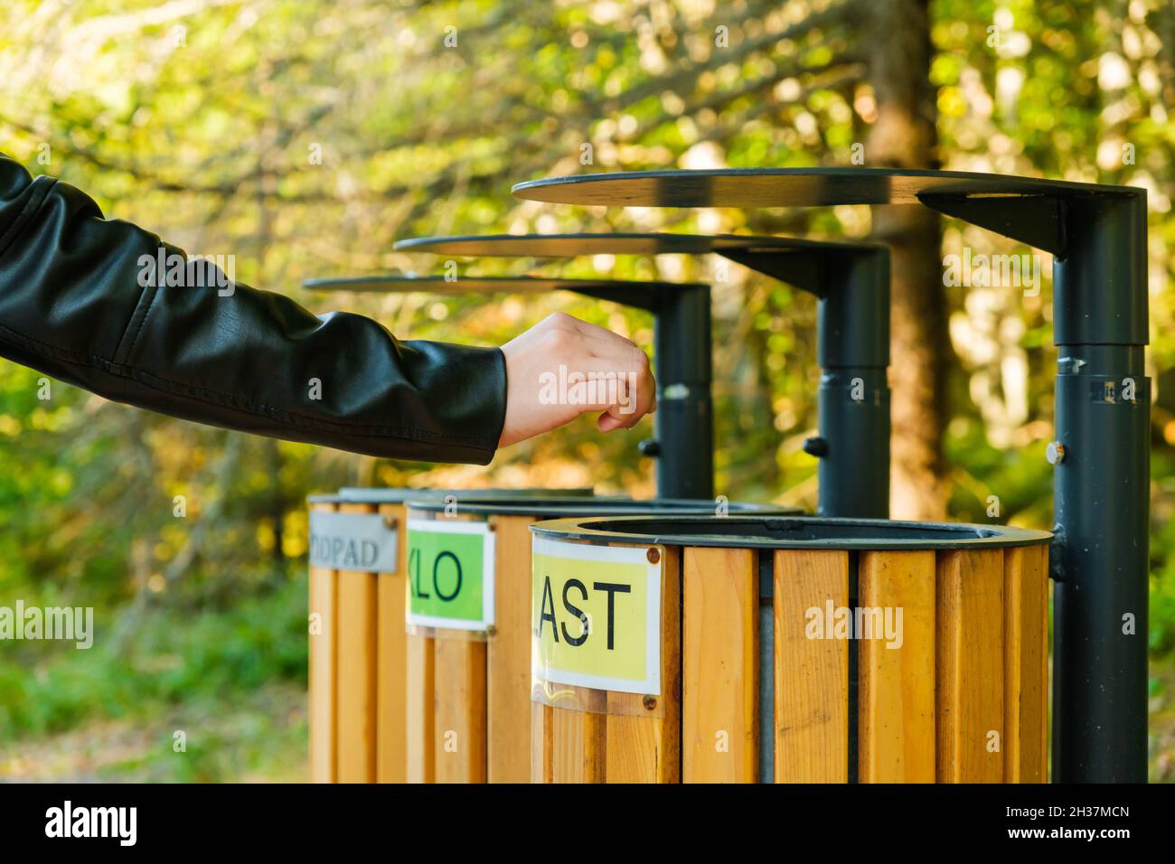 Woman throws out the trash. Waste sorting in the street Stock Photo - Alamy