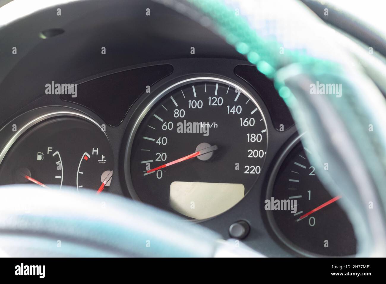 Car dashboard with speedometer and fuel level gauge. Closeup view ...