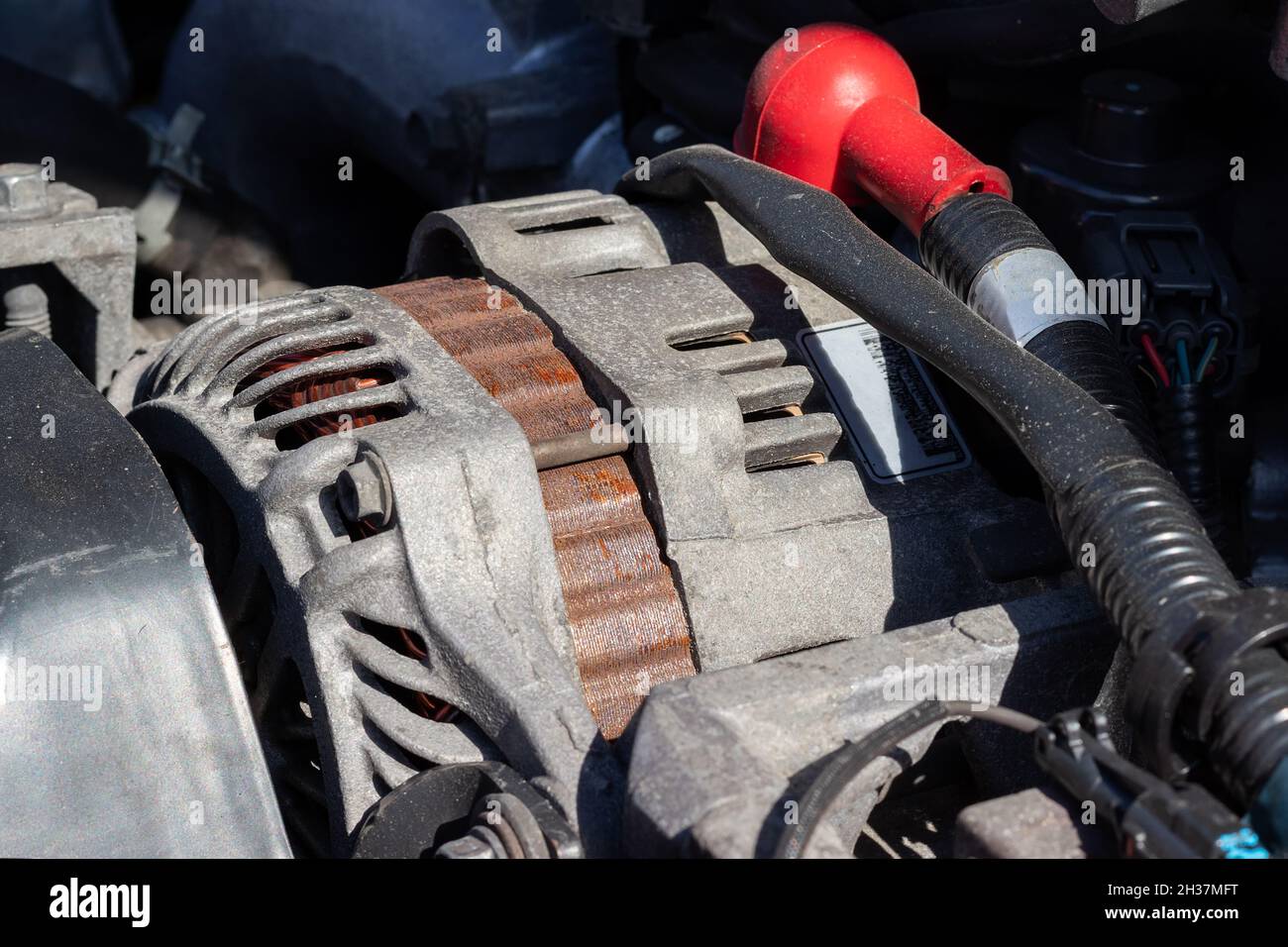 Alternator. Details of a flat-four (boxer) car engine compartment under ...