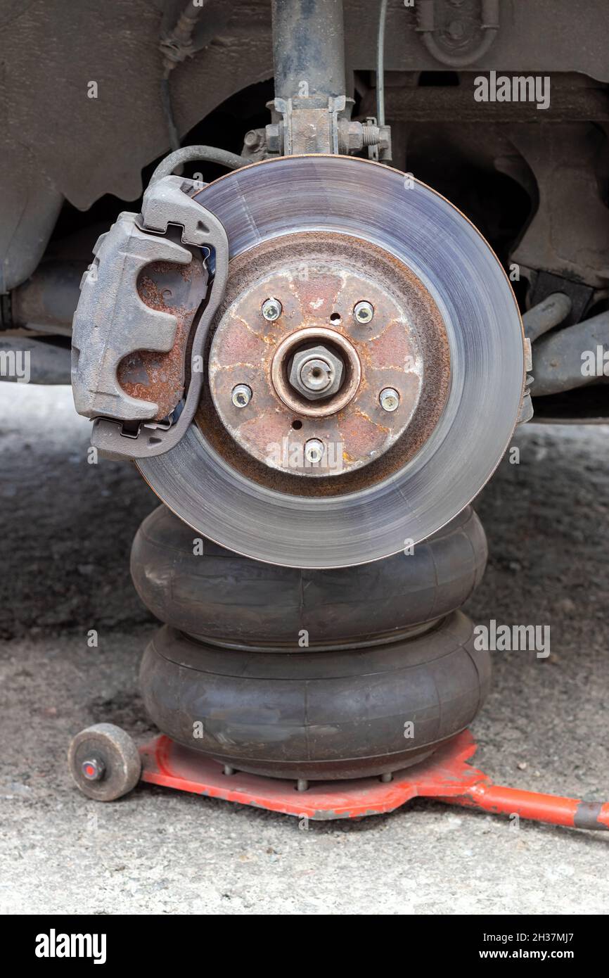 Rusty car wheel hub with brake disc at tire shop. Car without a wheel ...