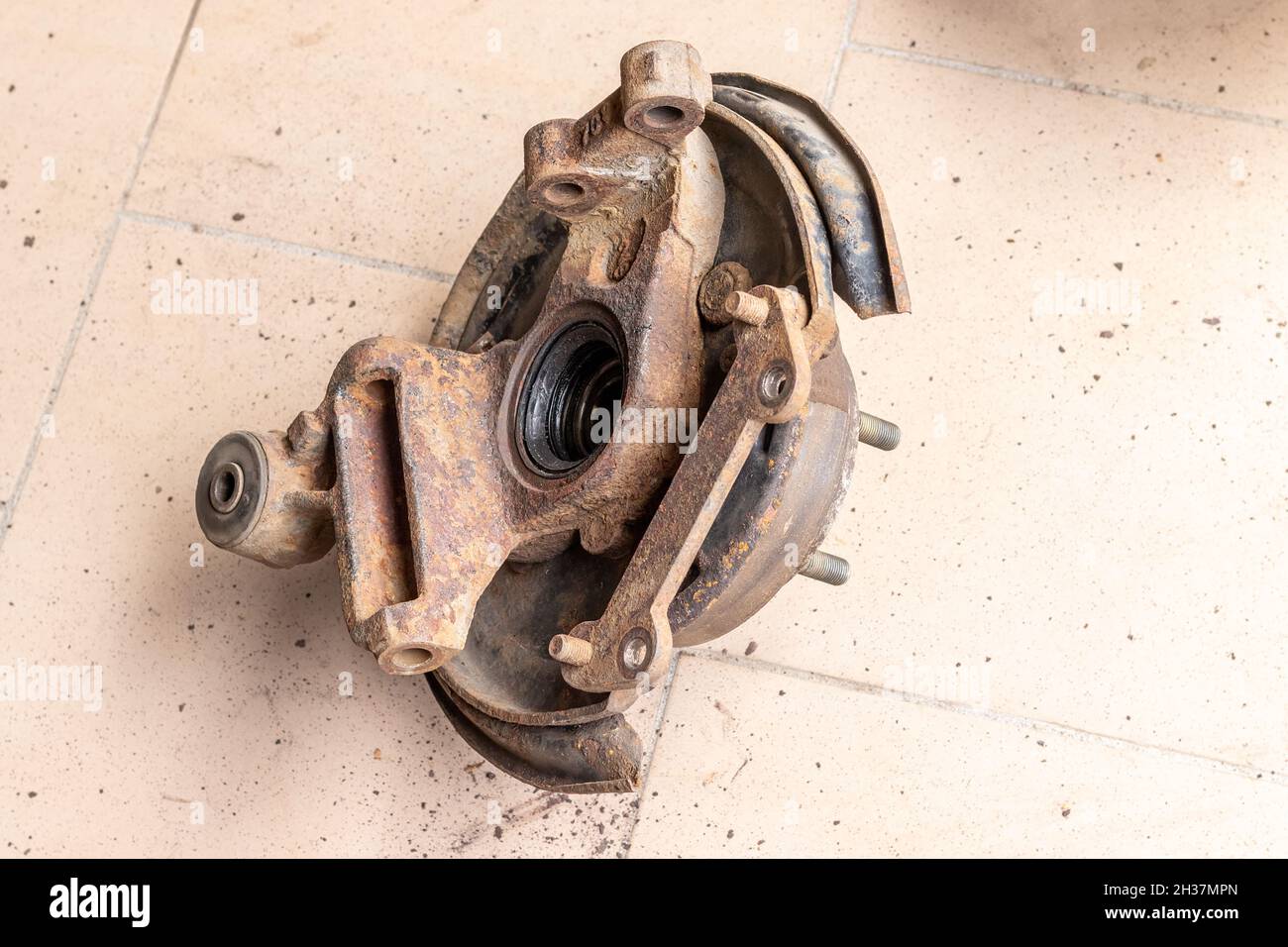 Old, used, rusty rear hub, inner part without brake disc, on the beige ...