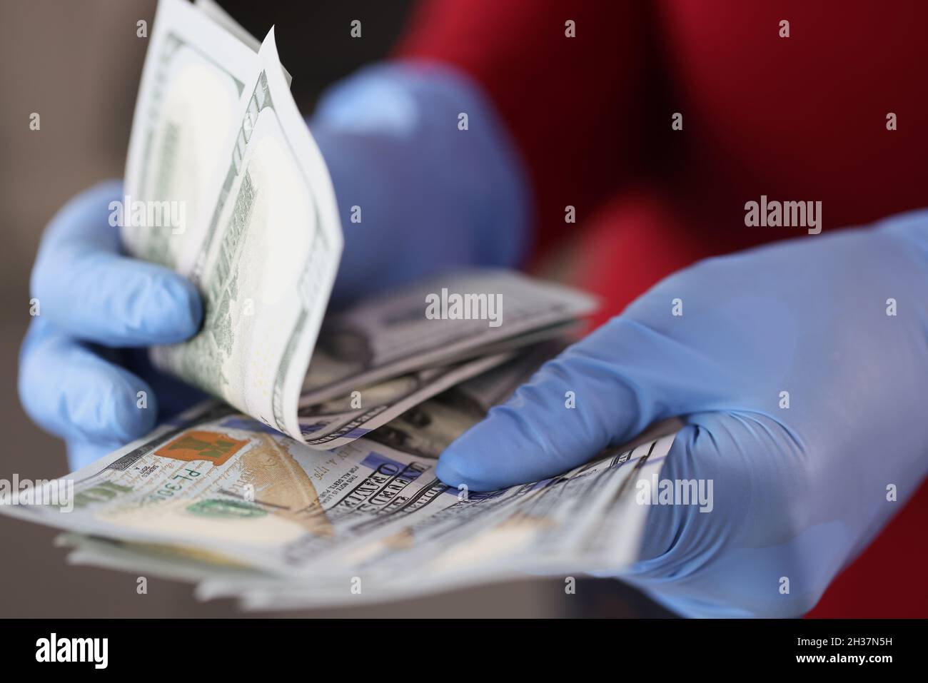 Hands in rubber gloves counting cash dollars closeup Stock Photo - Alamy