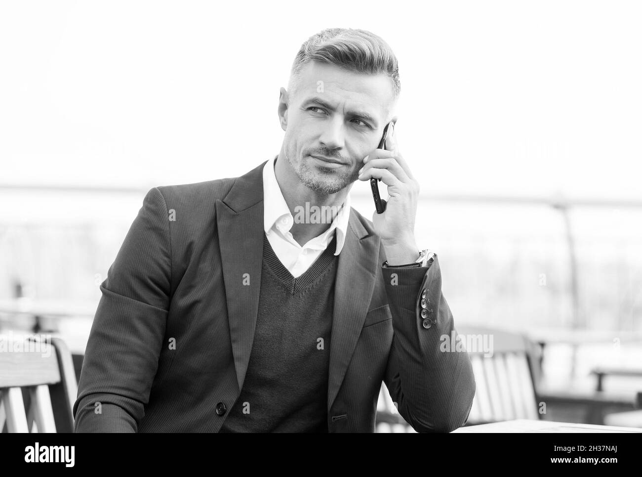 Serious man talking on smartphone Black and White Stock Photos & Images ...