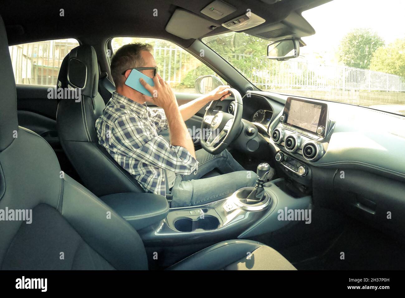 Man drive a car and use infotainment. Driver male reading messages and ...